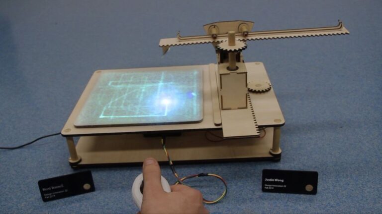 This joystick-controlled machine draws light trails using a laser ...