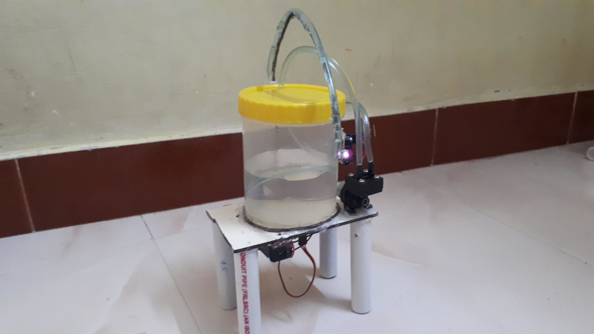 This auto-adjusting PVC system lifts hand sanitizer to the perfect ...