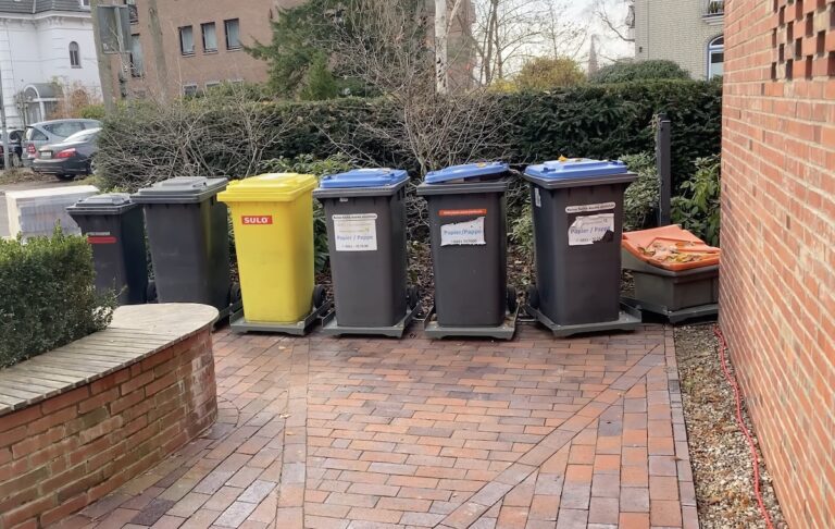 This train of trash bins moves to the curb with the press of a button ...